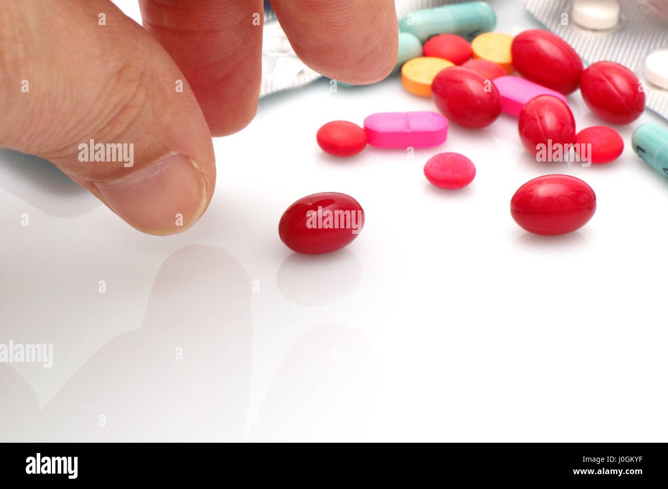 Hand picking up pills hi-res stock photography and images - Alamy
