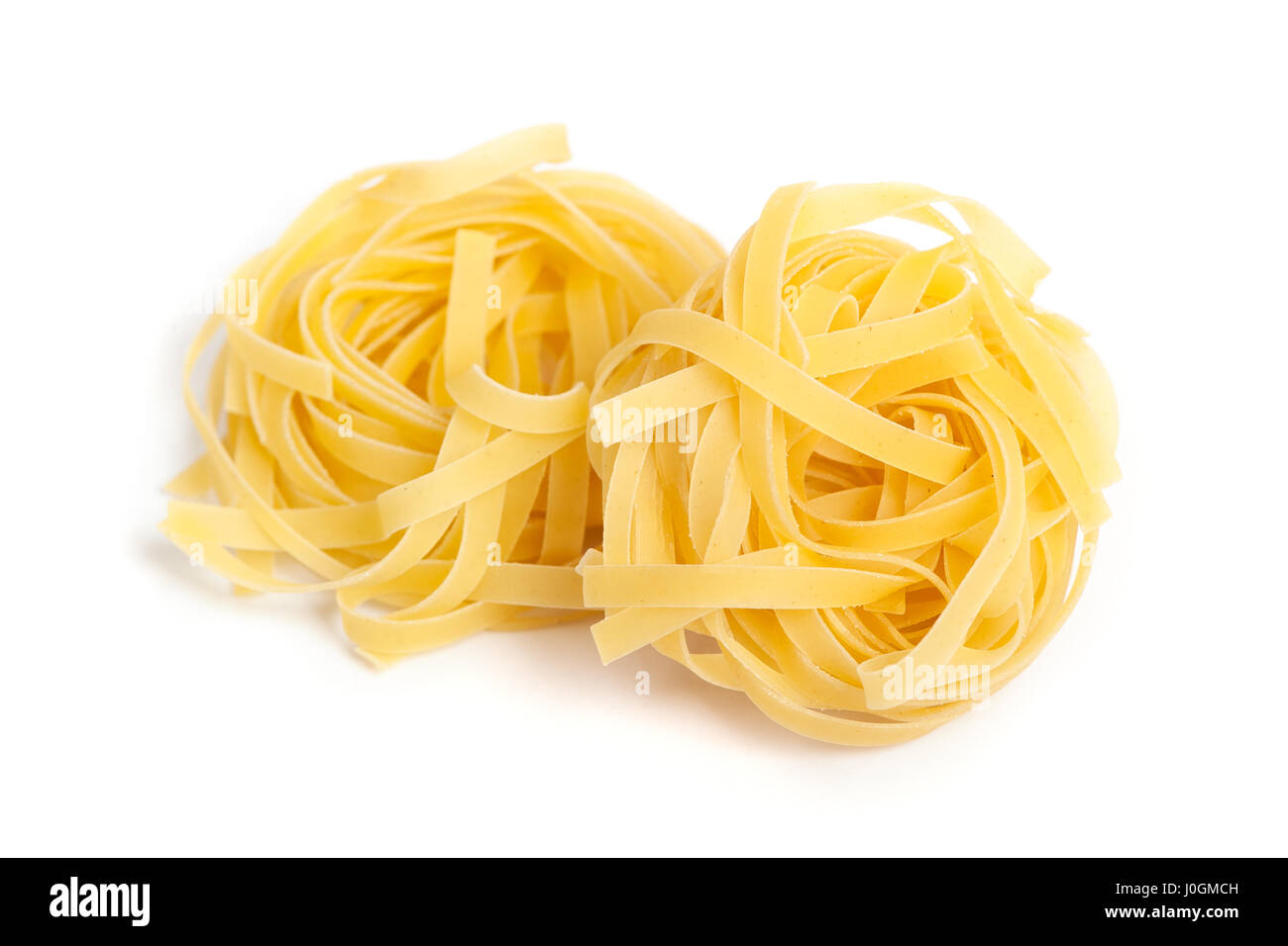 Pasta nests isolated on white background Stock Photo - Alamy