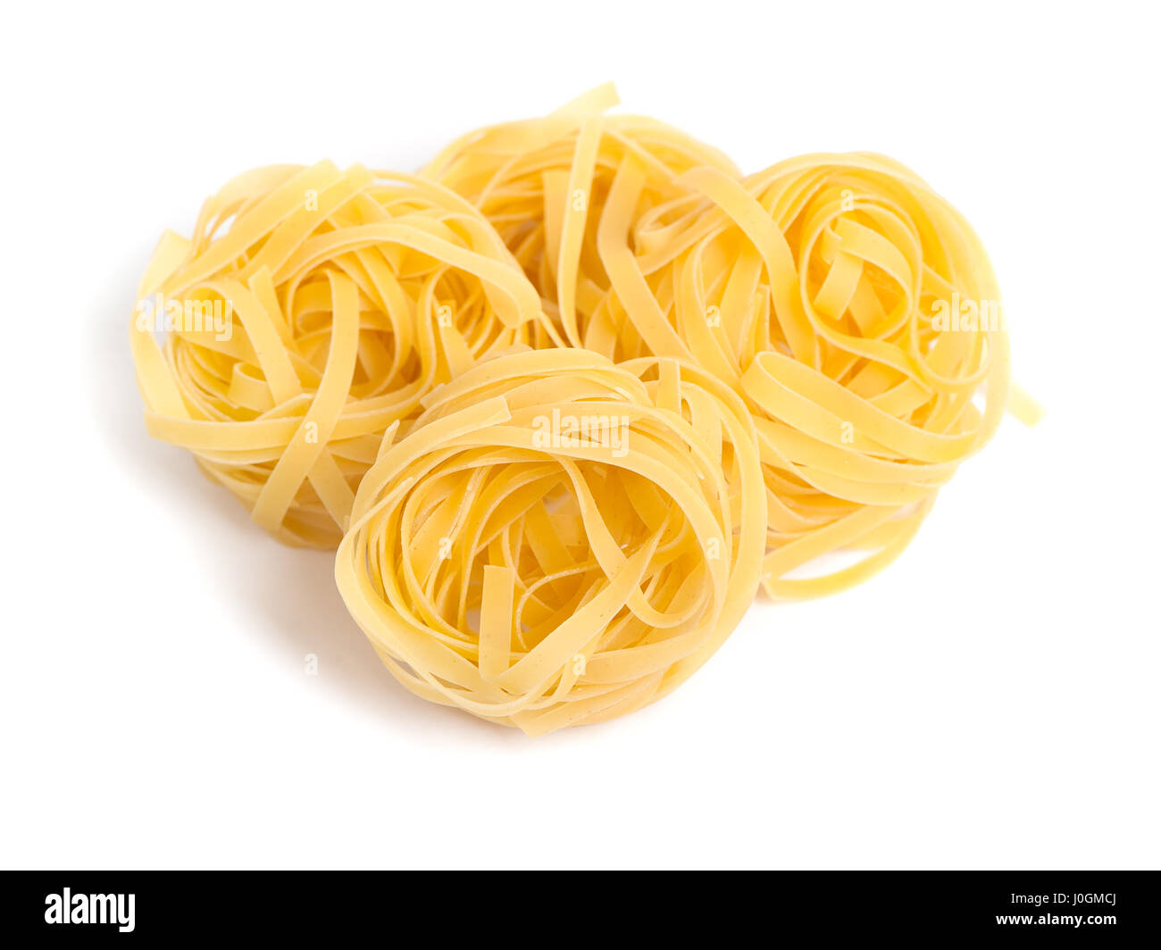 Pasta nests isolated on white background Stock Photo - Alamy
