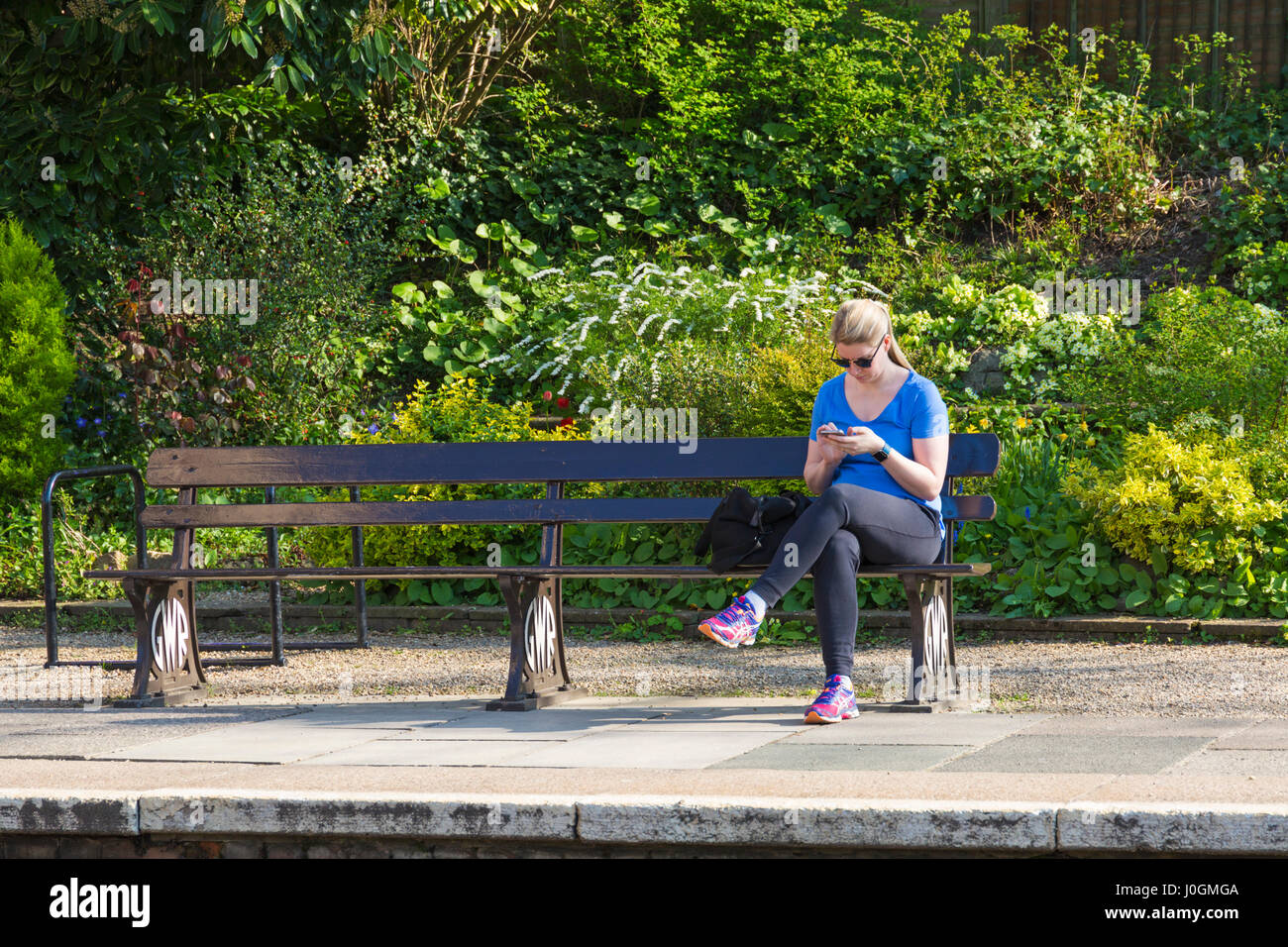 Young woman sitting train station hi-res stock photography and images ...