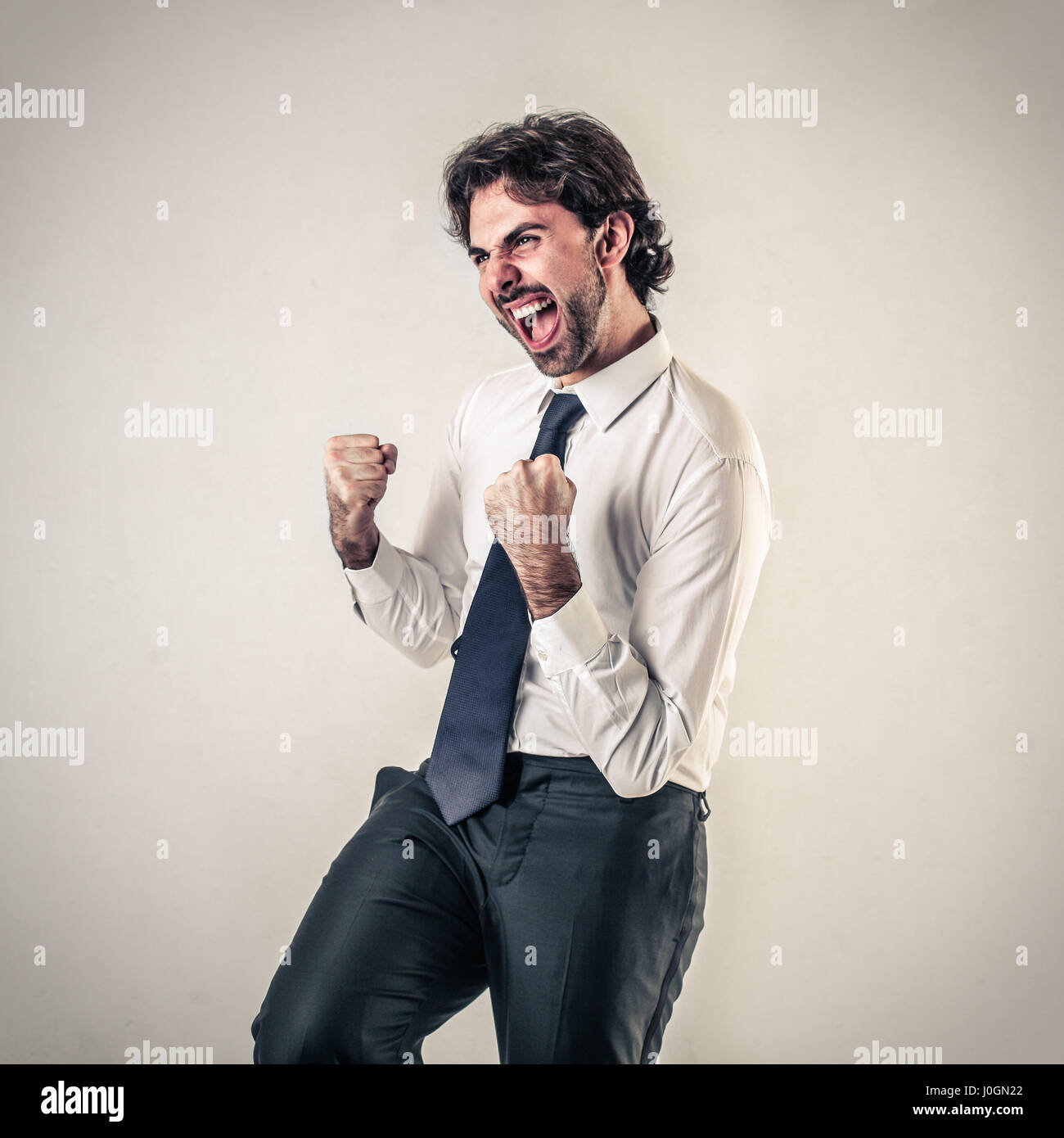Businessman feeling victorious Stock Photo - Alamy