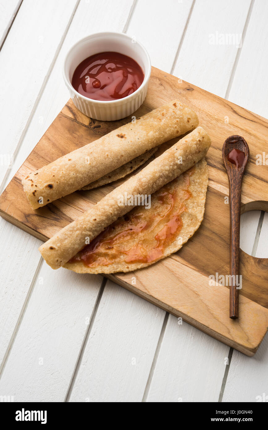 indian bread or chapati or paratha rolled with fruit jam, typical ...