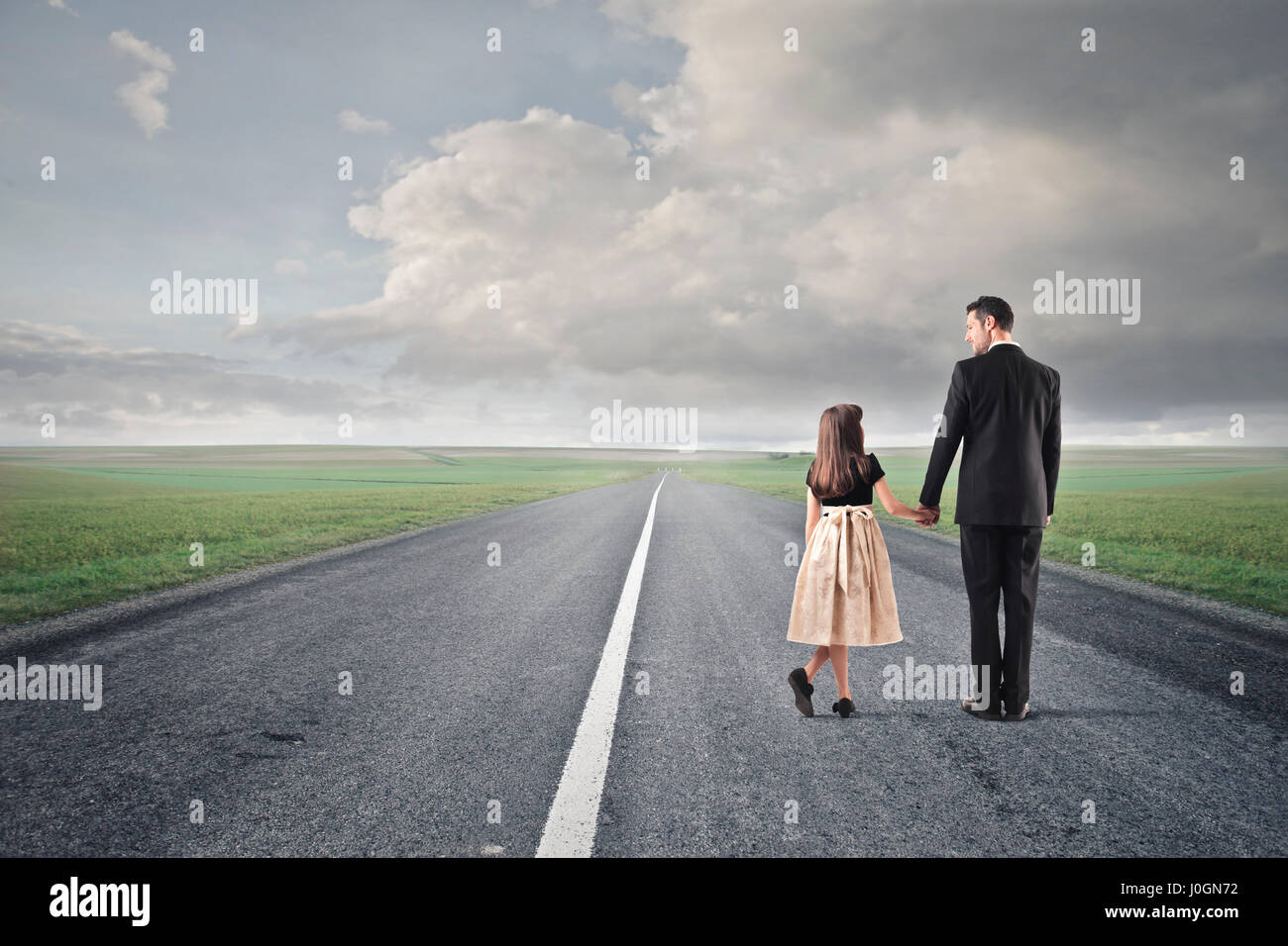 Father and daughter walking on the road Stock Photo - Alamy
