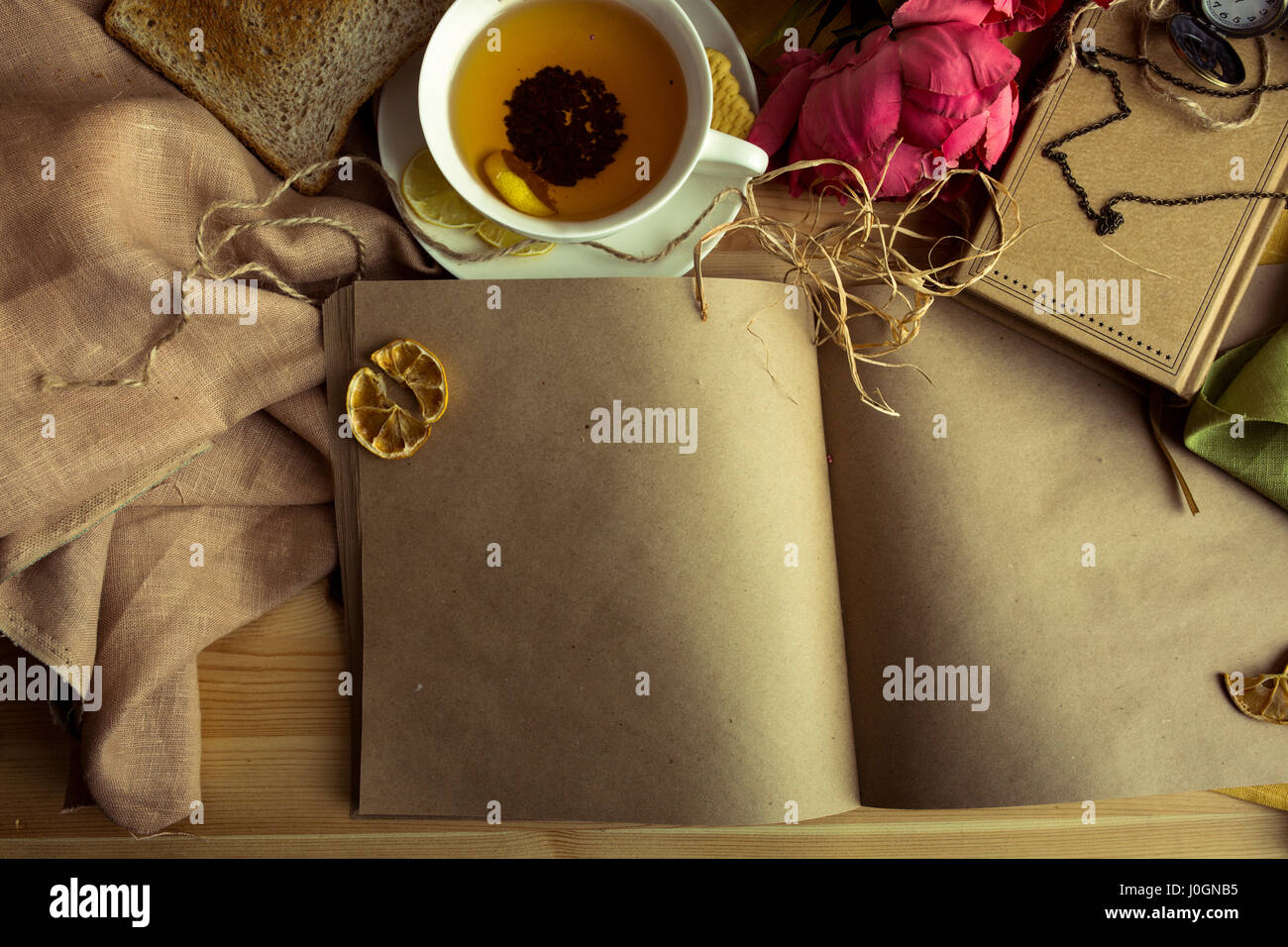 Craft paper note with cup of tea, flowers, peonies, old vintage clock ...