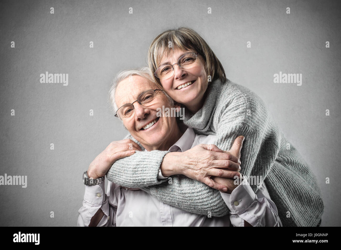 Old couple hugging each other Stock Photo - Alamy