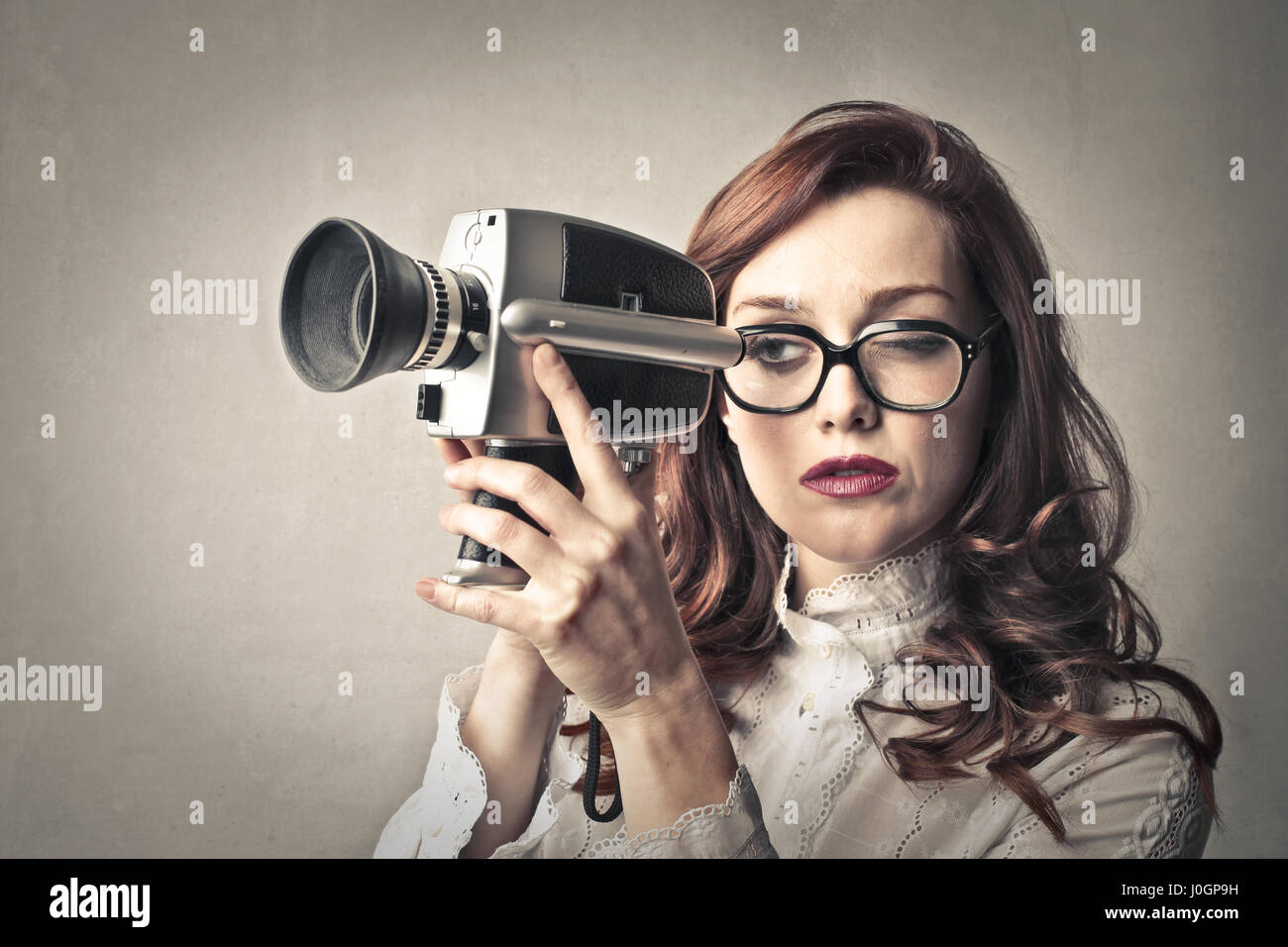 Young woman shooting with old video camera Stock Photo - Alamy