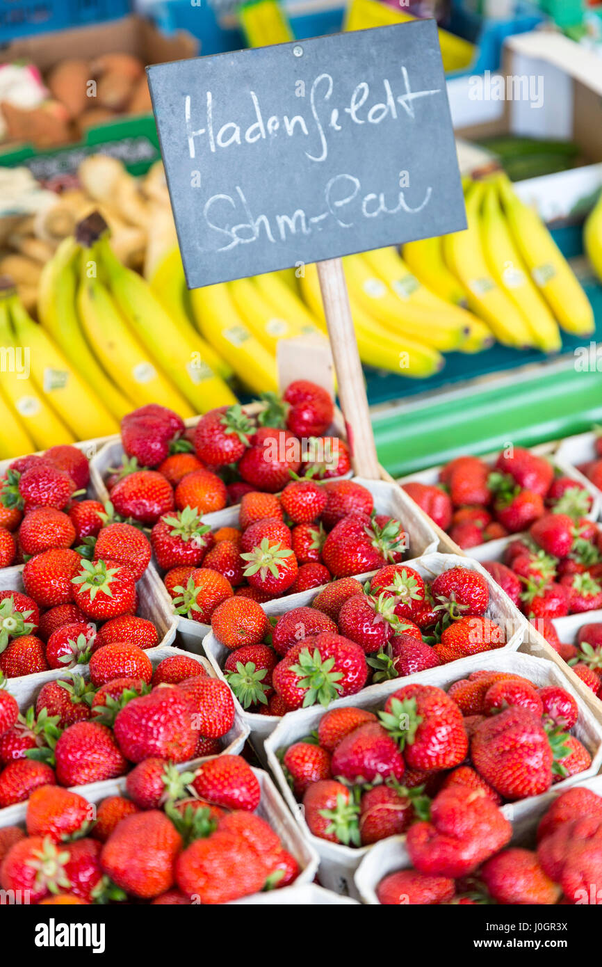 Strawberries and bananas in display of fruits at food market in Lubeck ...