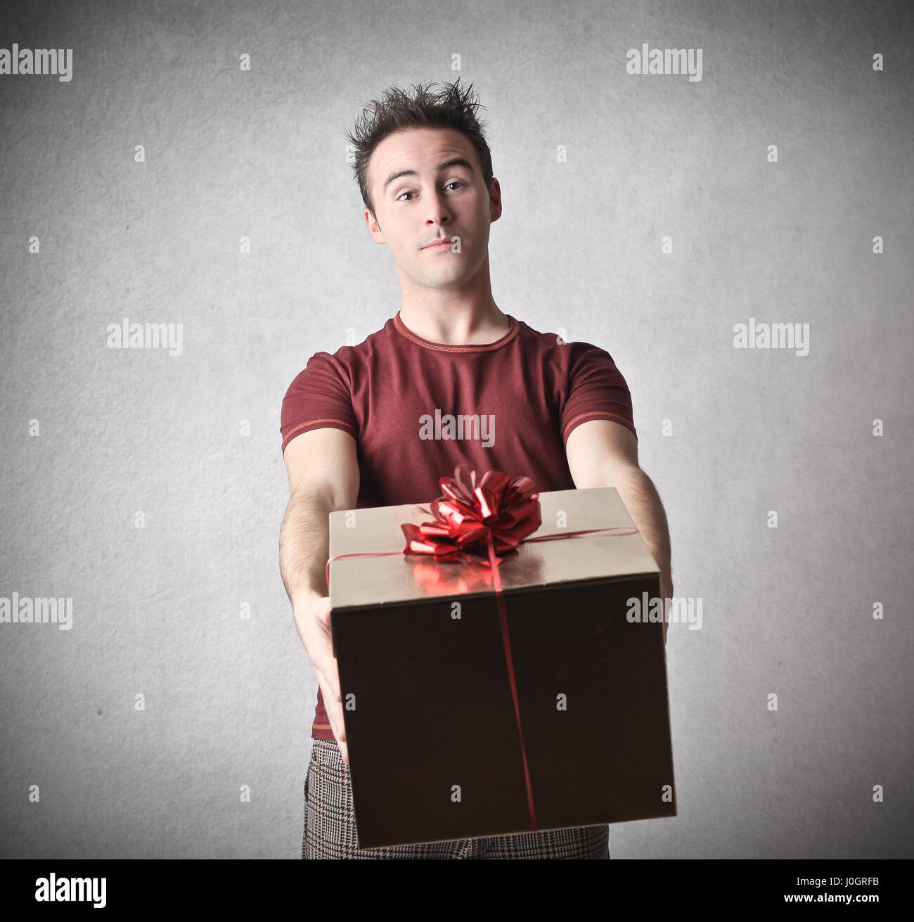 Man holding big present Stock Photo - Alamy