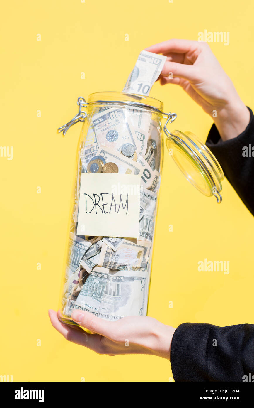 Hand holding money putting glass hi-res stock photography and images ...