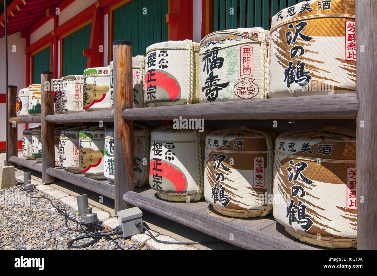 A stack of sake or rice wine barrels from various manufacturers stacked ...