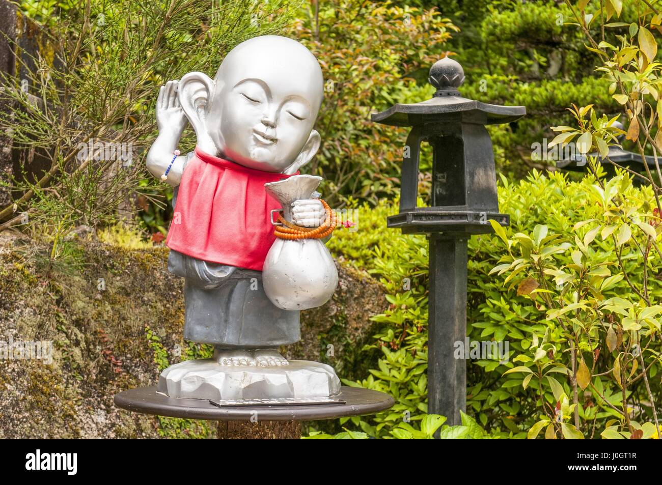 Budda statue stands peacefully at the Daisho in temple of Miyajima ...