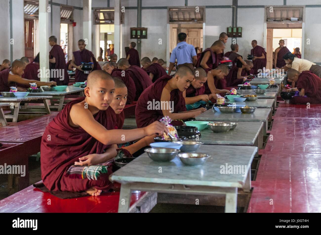 Buddhist student monks eating lunch in their dining room at the ...