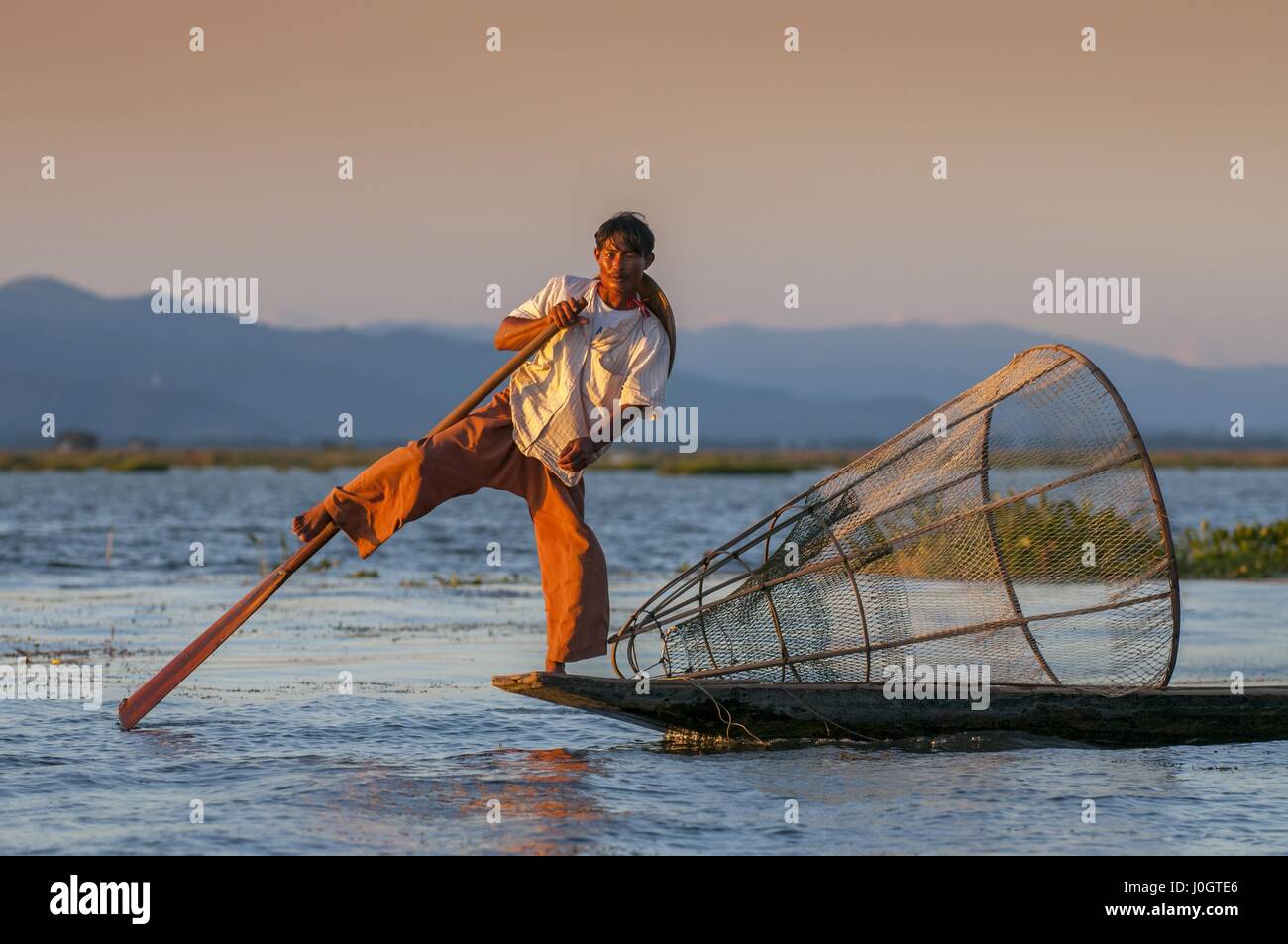 Traditional Burmese fishermen with fishing net at Inle lake in Myanmar ...