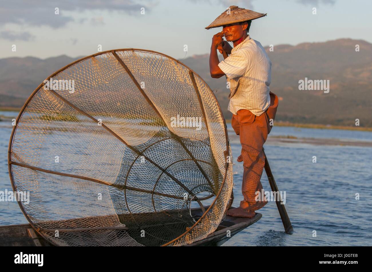 Traditional Burmese fishermen with fishing net at Inle lake in Myanmar ...