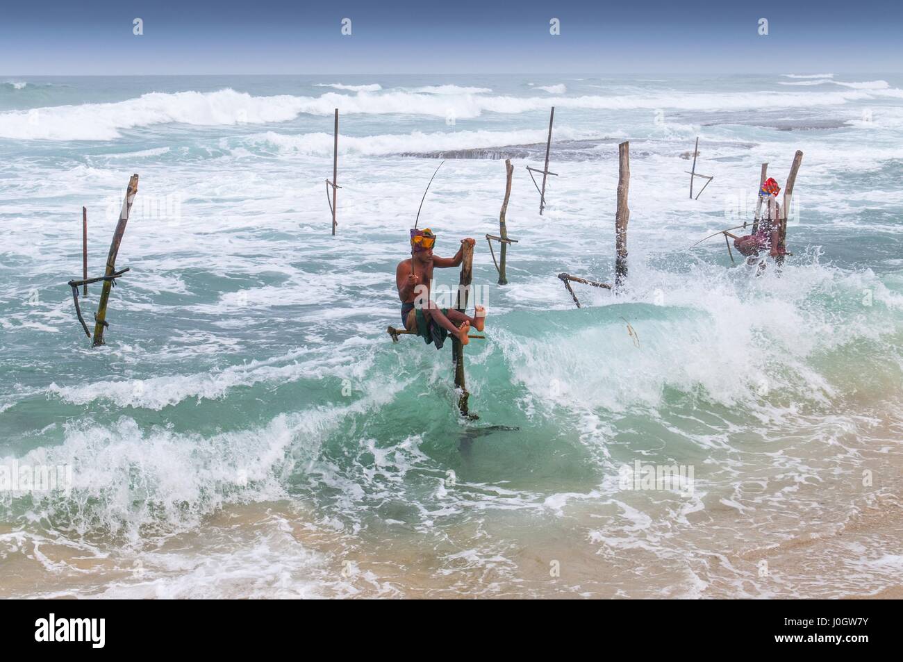 Stilt fishing is fishing in shallow water on a platform made up of a ...