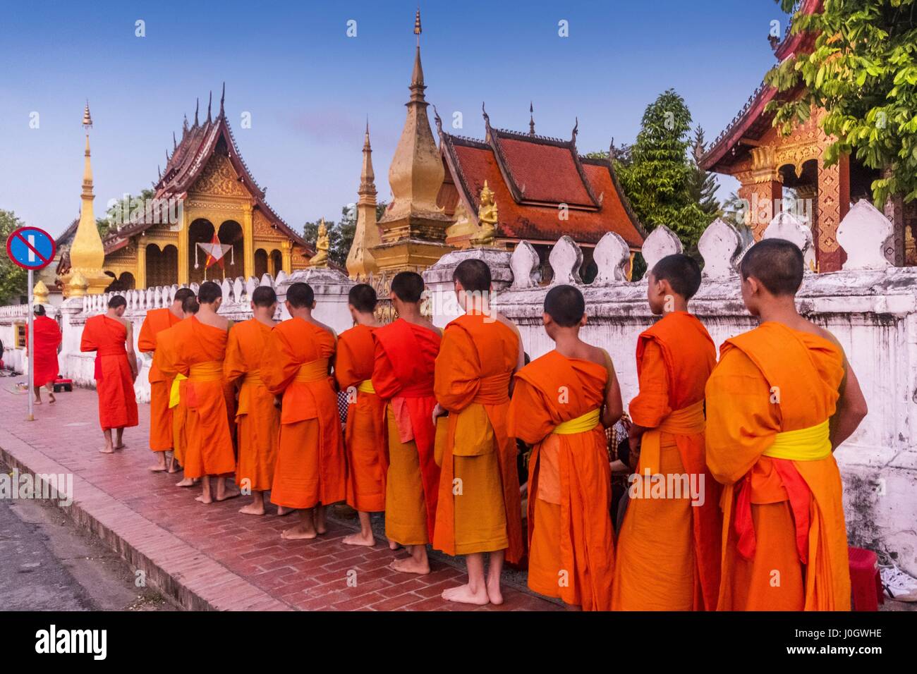 Young monks at the alms giving ceremony in front of the Wat Sene, Luang ...