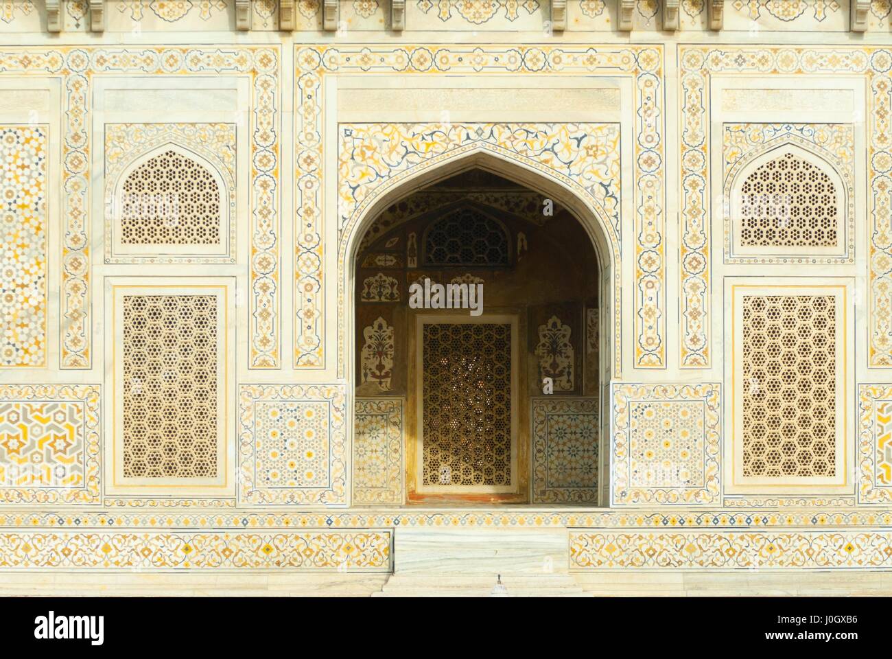 The doorway and windows screen of the ornate white marble Mughal tomb ...