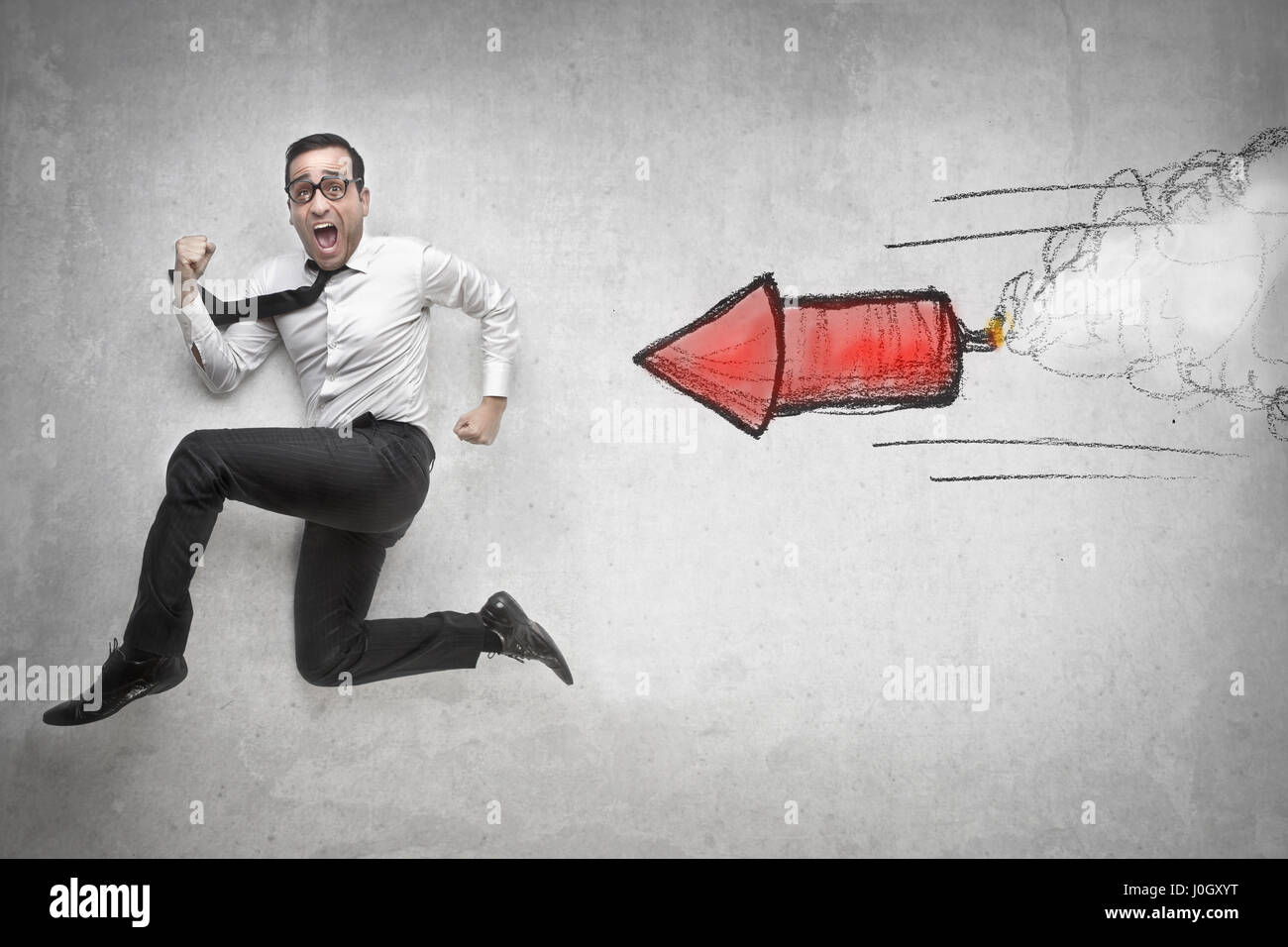 Businessman running from drawn rocket Stock Photo - Alamy