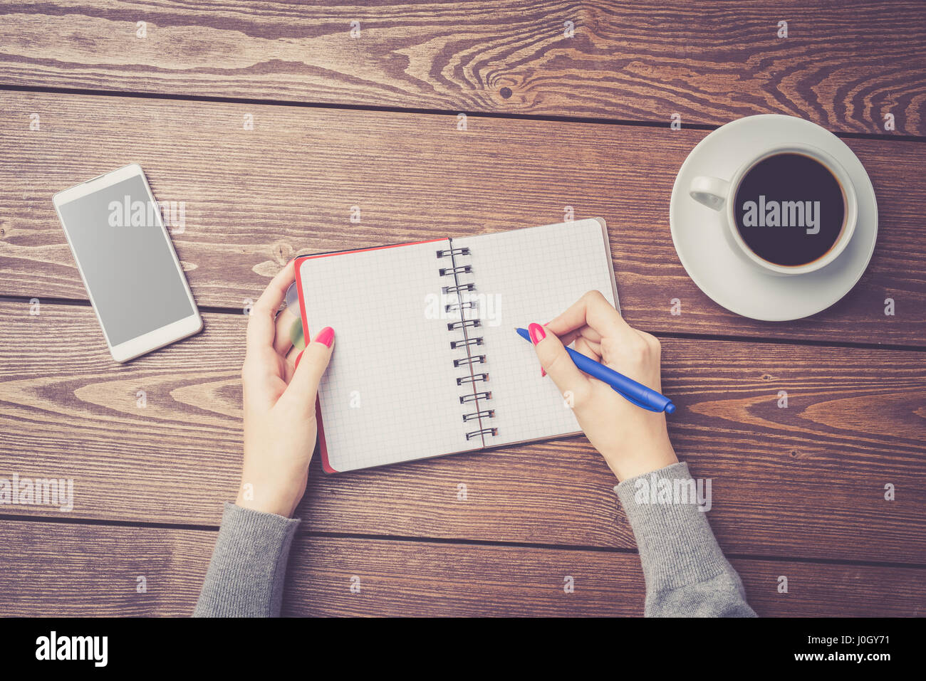 Woman writing in empty notebook. Top view Stock Photo - Alamy