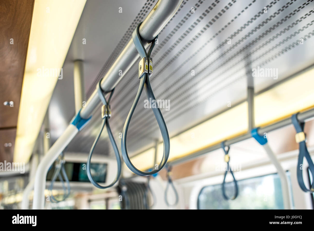 Handles for standing passenger inside a bus Stock Photo - Alamy