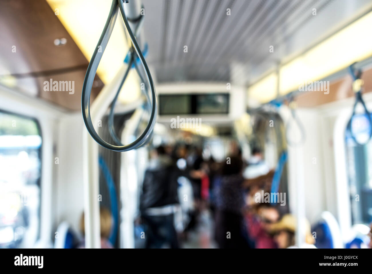 Handles for standing passenger inside a bus Stock Photo - Alamy