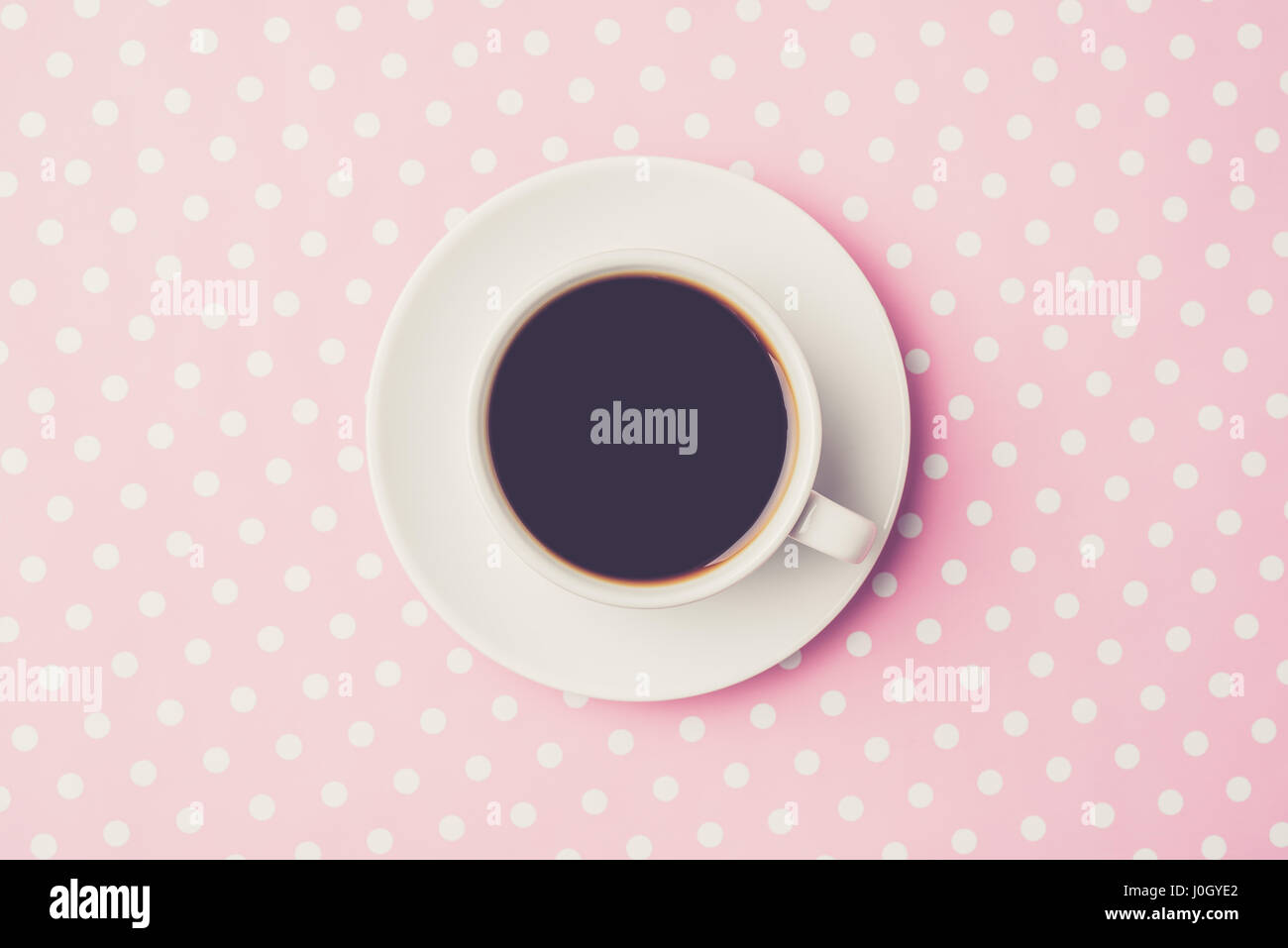 Coffee cup on pink dotted table Stock Photo - Alamy