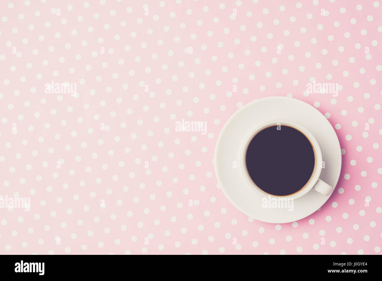 Coffee cup on pink dotted table Stock Photo - Alamy
