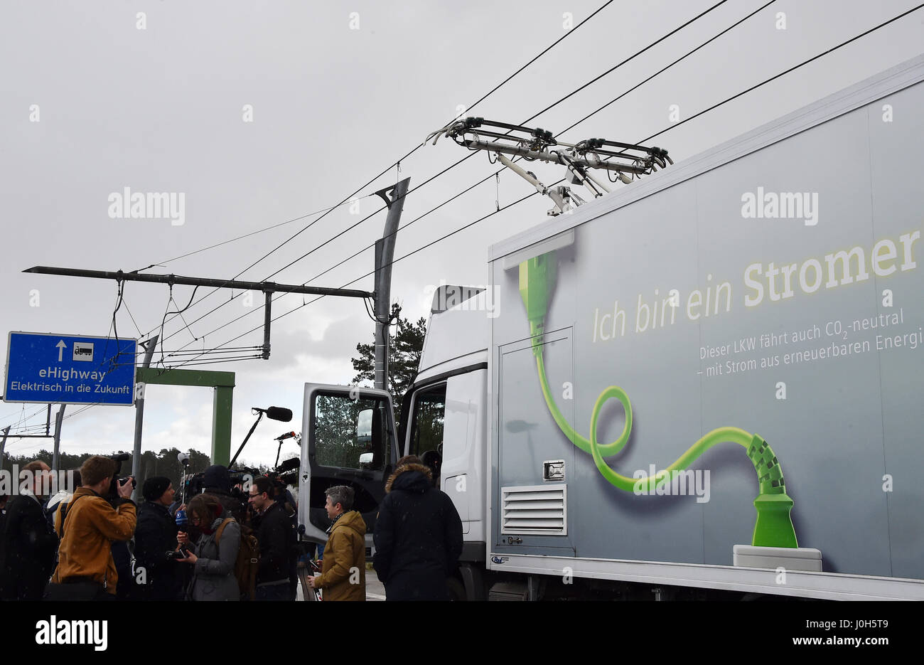 A truck powered by electric overhead lines drives along an 'eHighway ...