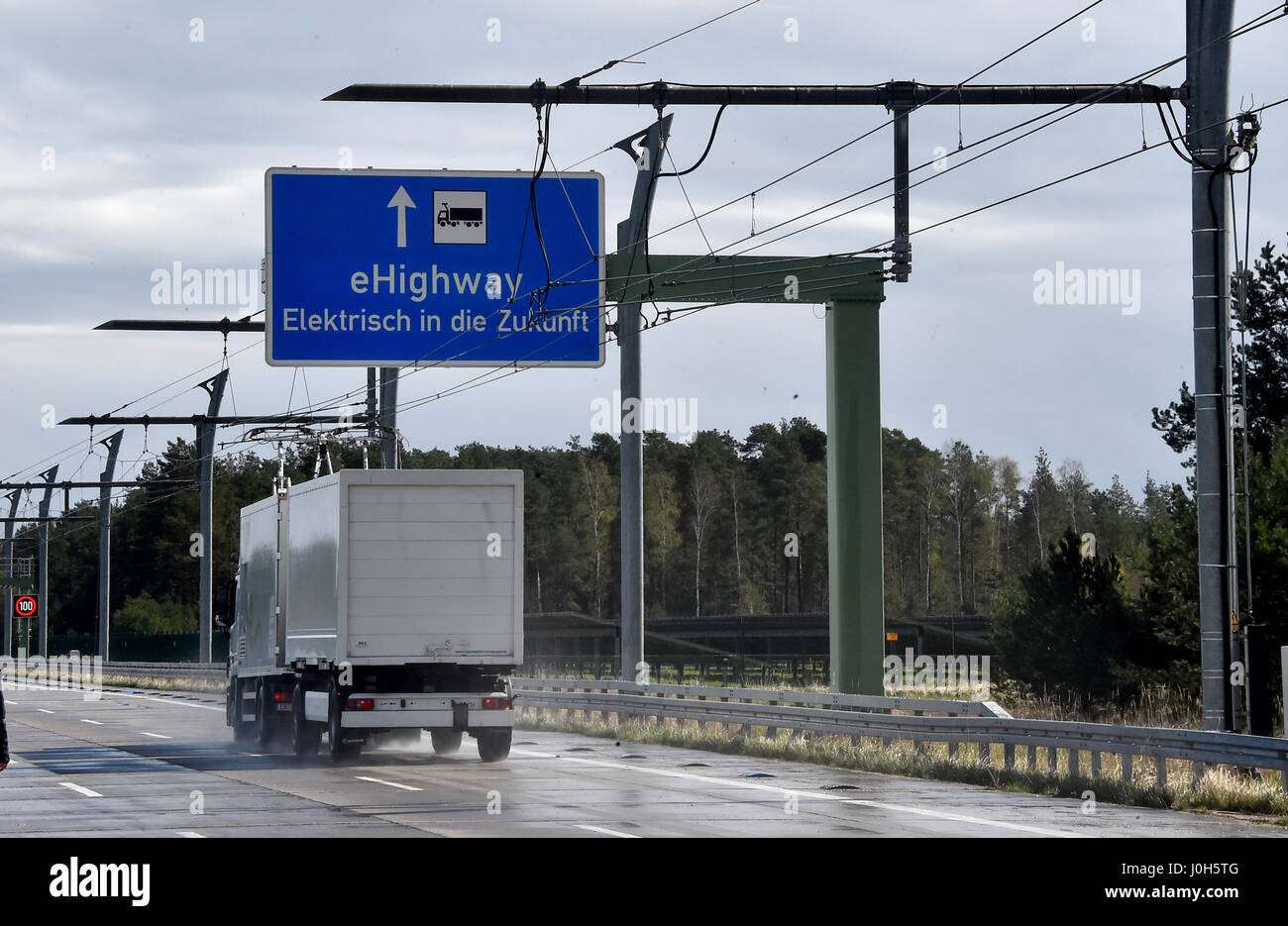 A truck powered by electric overhead lines drives along an 'eHighway ...