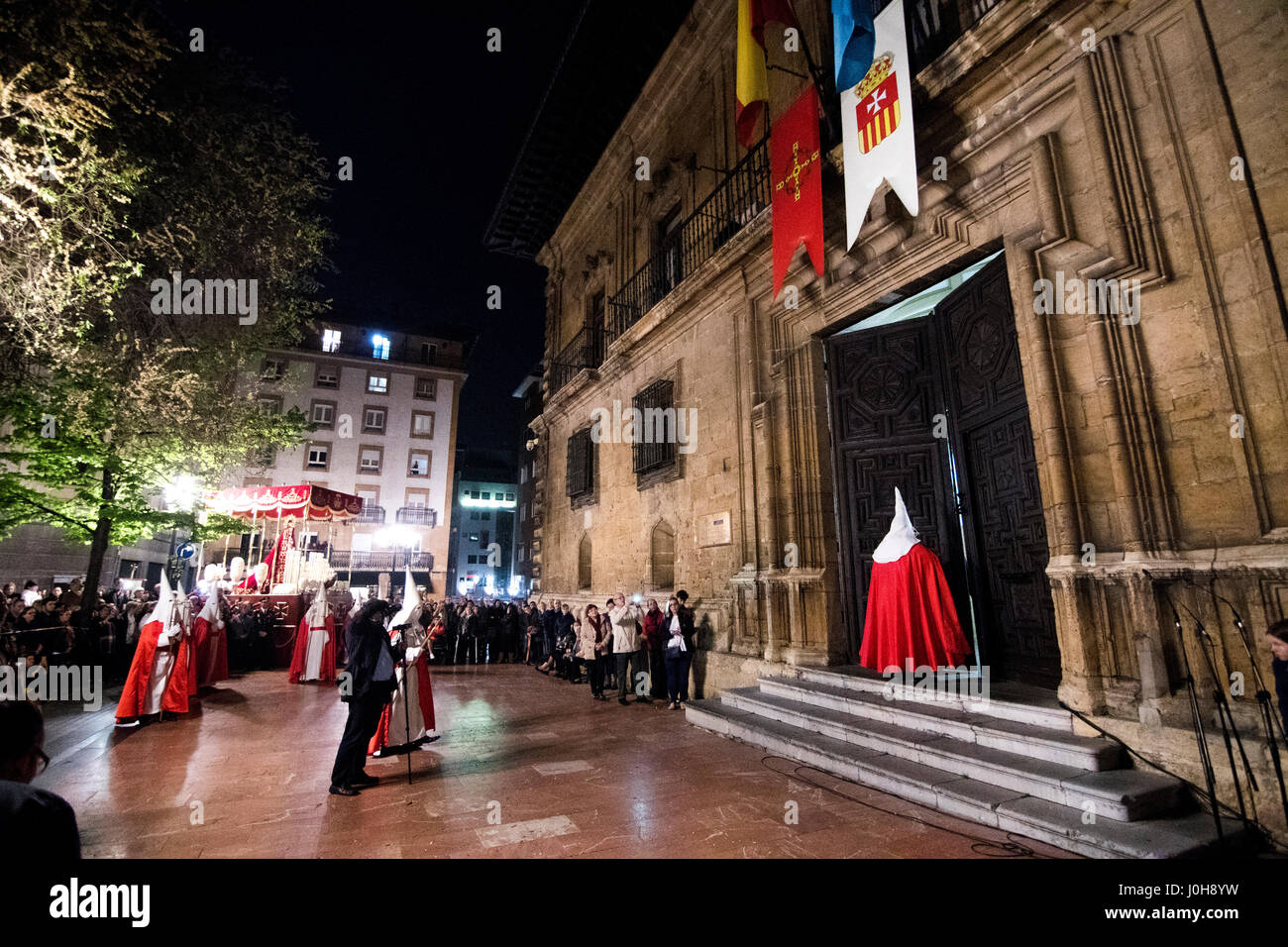 Ovied, Spain. 13th April, 2017. A nazarene open the door of a church ...