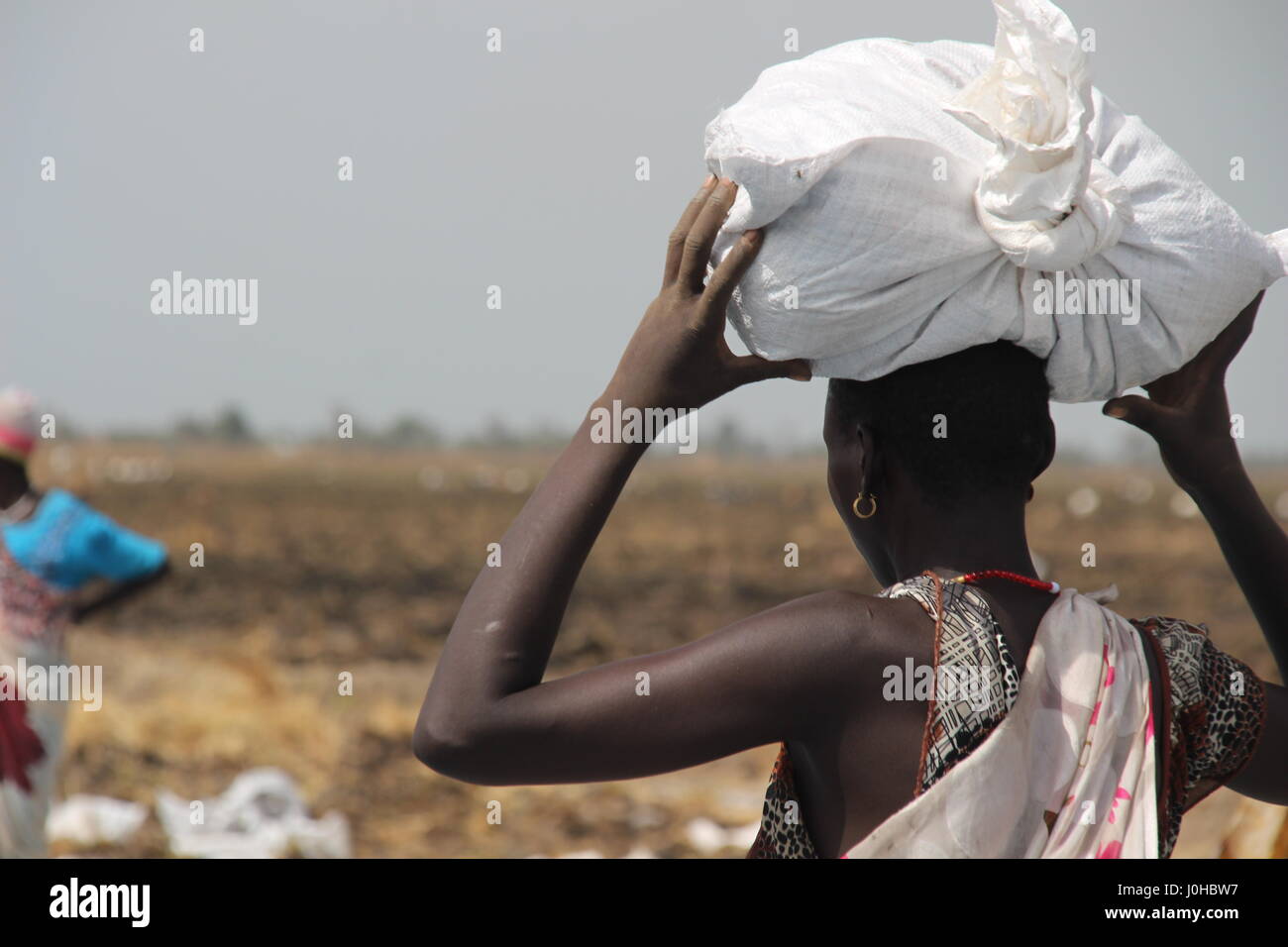 Ganyliel, South Sudan. 24th Mar, 2017. A woman carries a bag of relief ...