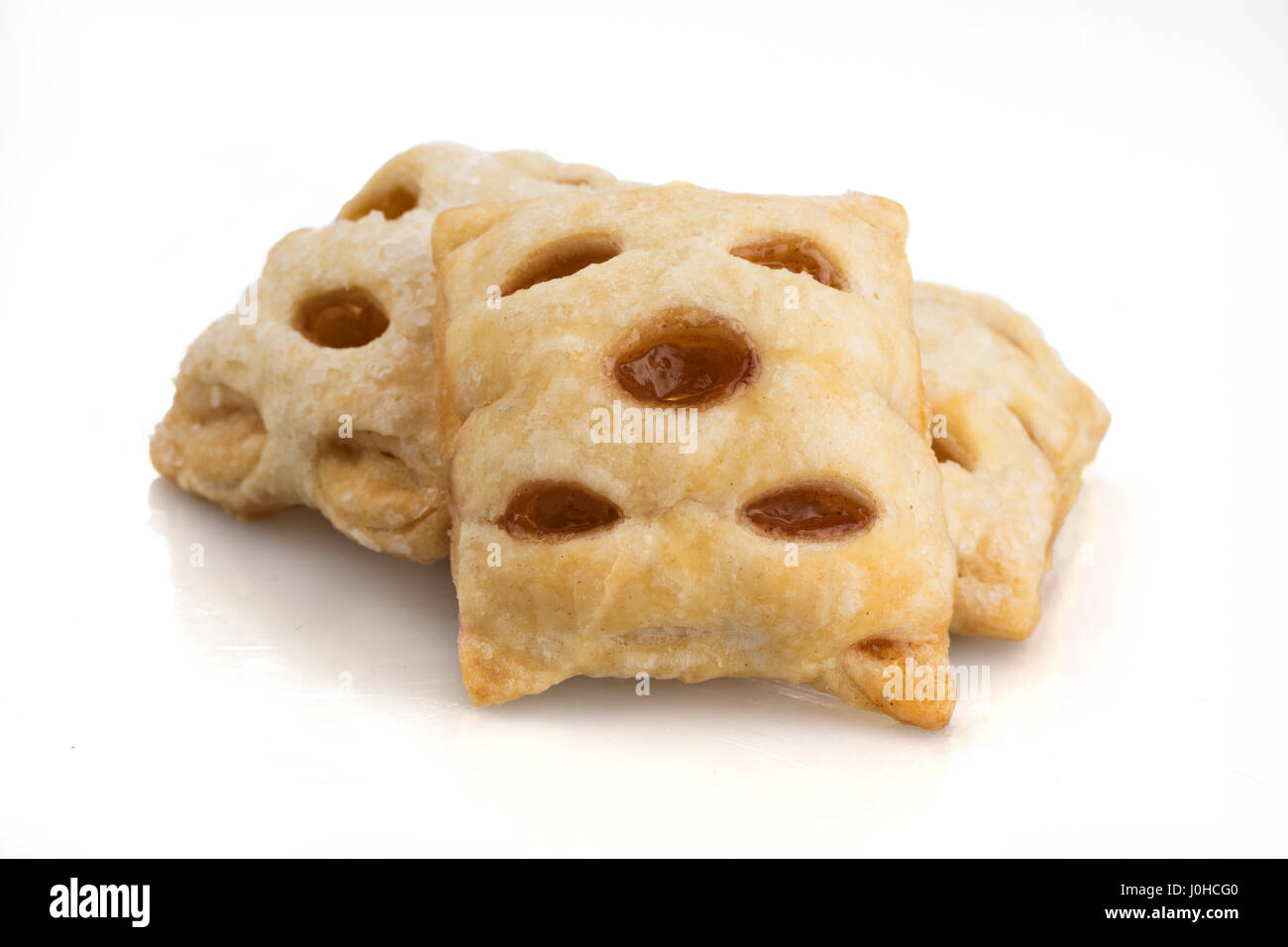 Three apple filled mini strudels on a white background Stock Photo - Alamy