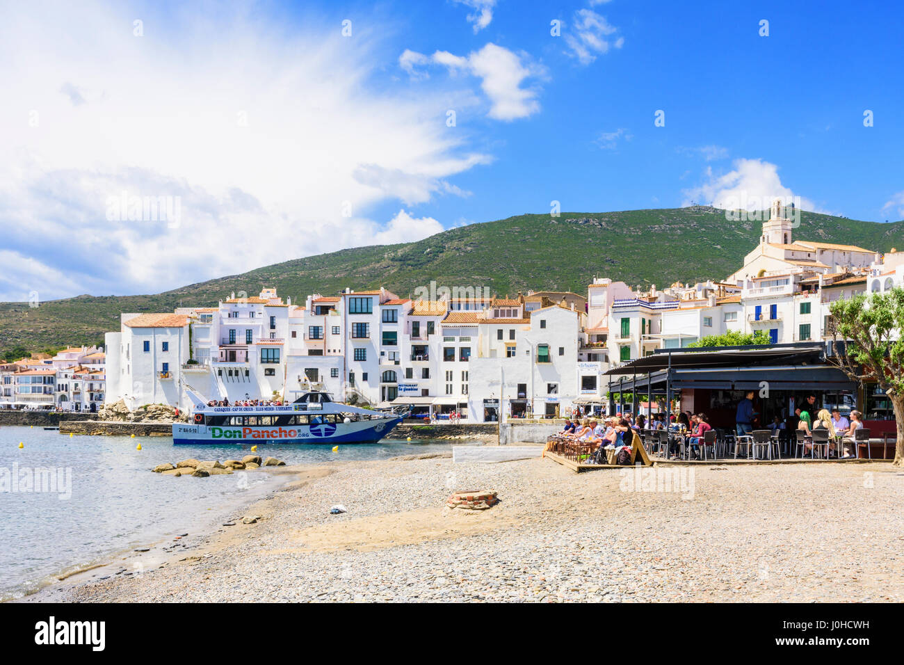 Picturesque beach bar and waterfront whitewashed buildings of Cadaques ...