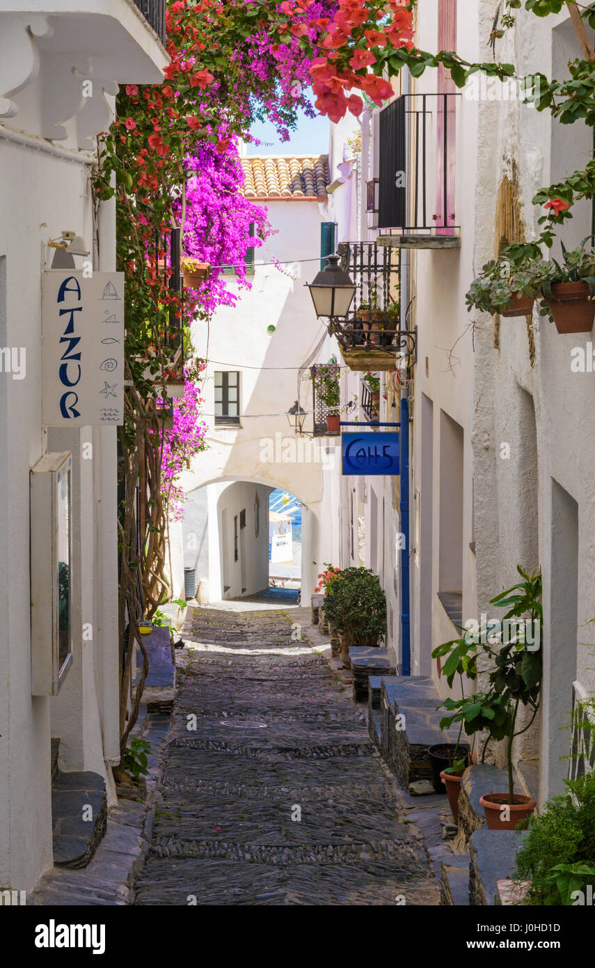 Whitewashed old town buildings along a rastell cobbled street decorated ...