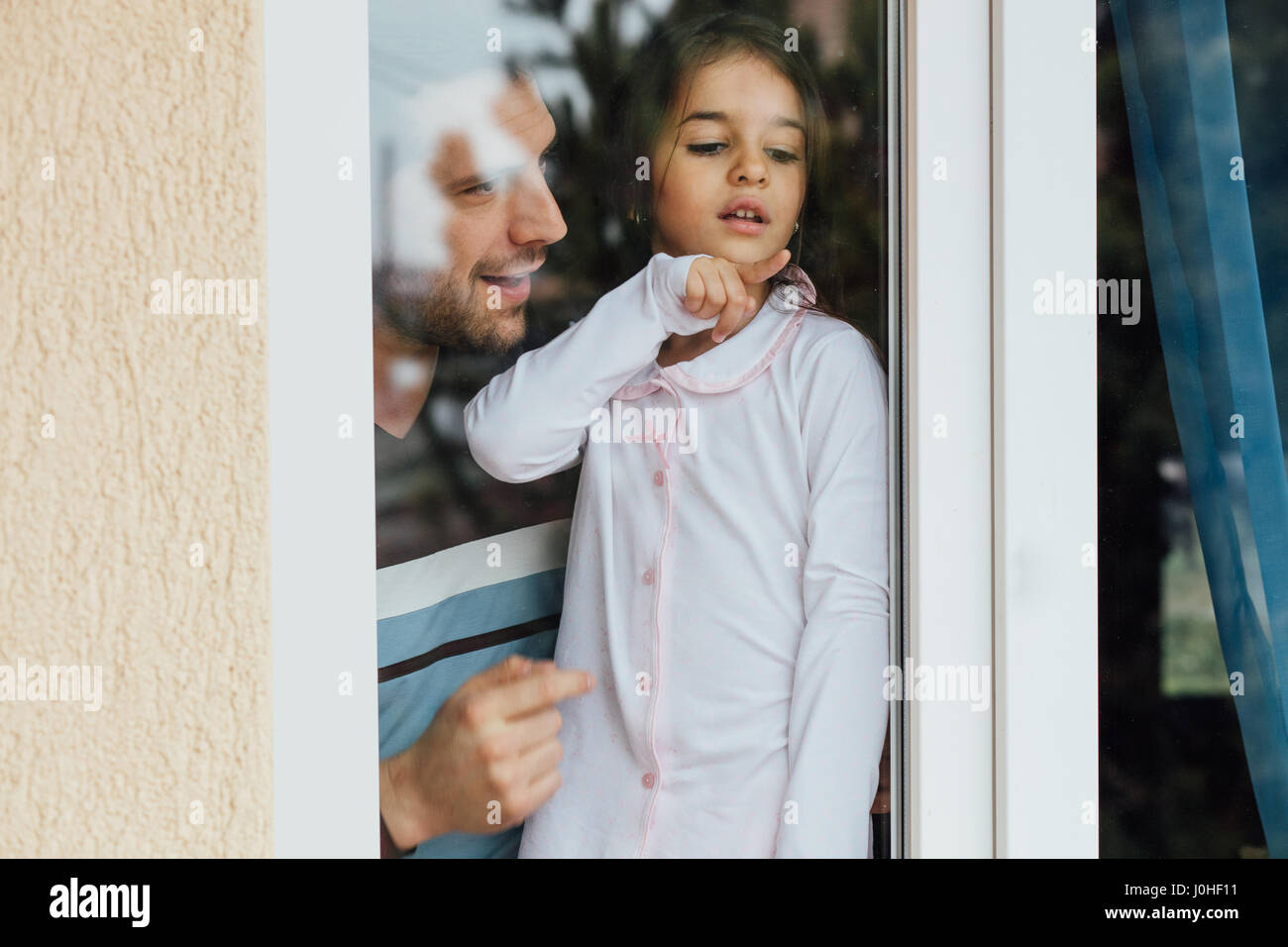 father and daughter looking out the window and smiling Stock Photo - Alamy