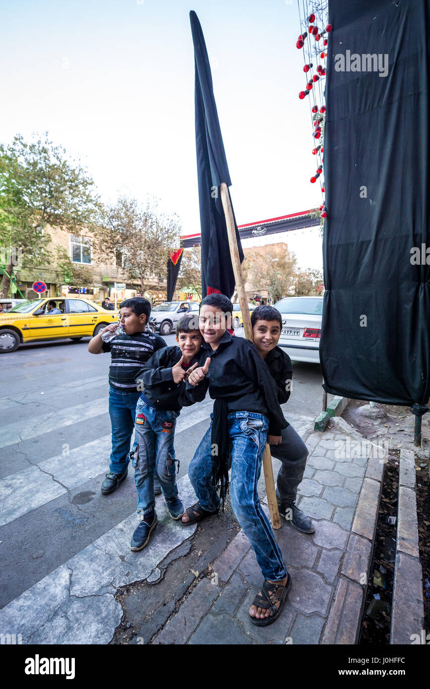 Iranian boys posing for photo on the old Bazaar of Kashan city, capital ...