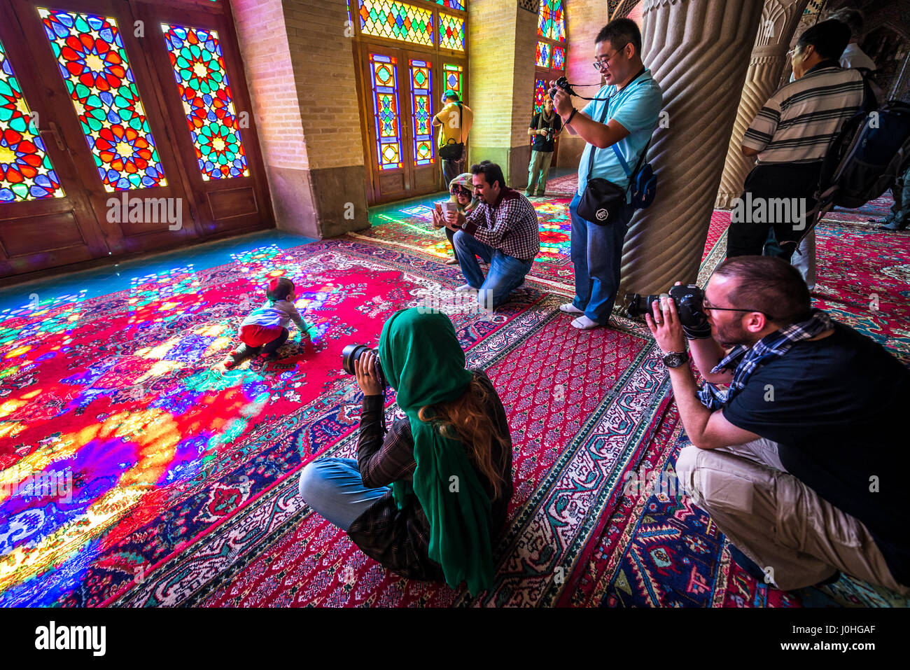 Tourists takes pictures of Iranian baby in so called Pink Mosque (Nasir ...