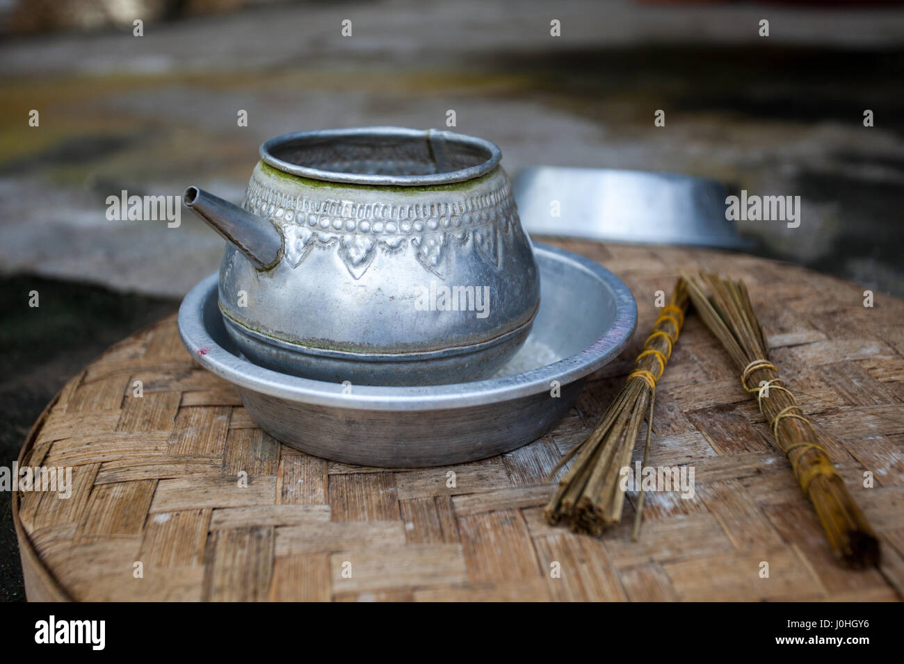 Traditional old aluminum kettle and incense for ceremonies in the ...