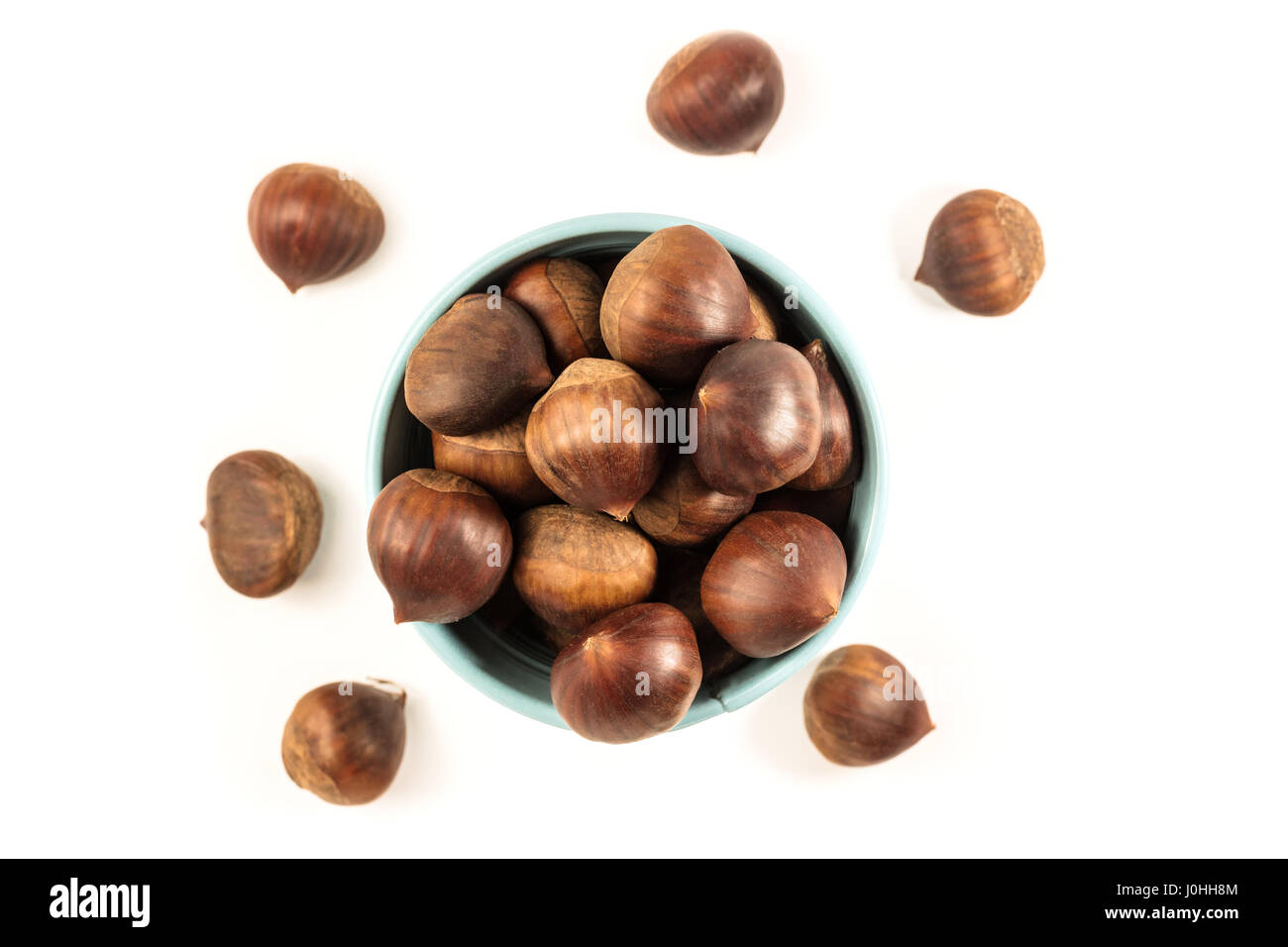 Chestnuts in small bucket, on white with copyspace Stock Photo - Alamy