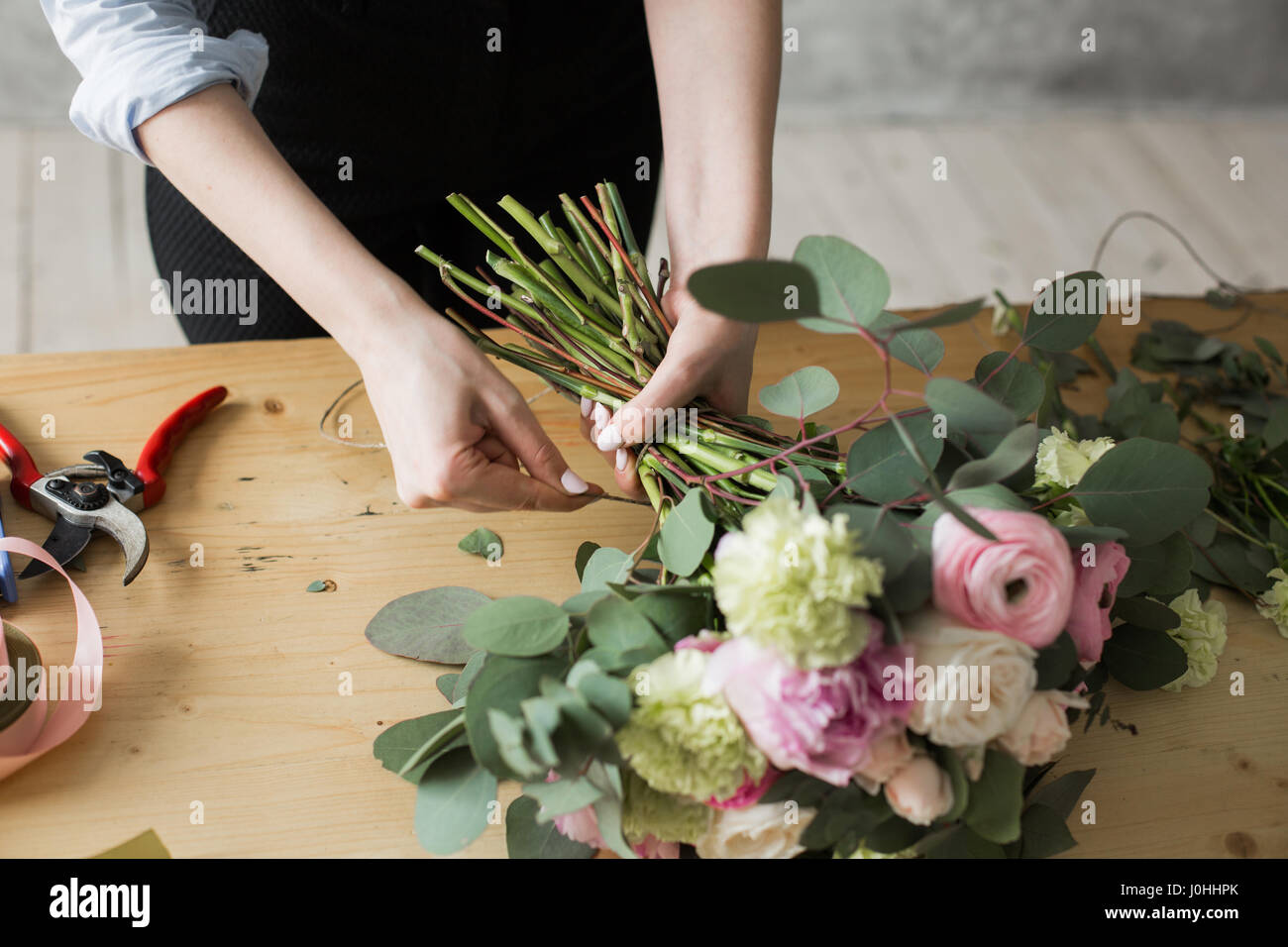 Florist at work: pretty young woman making fashion modern bouquet of ...