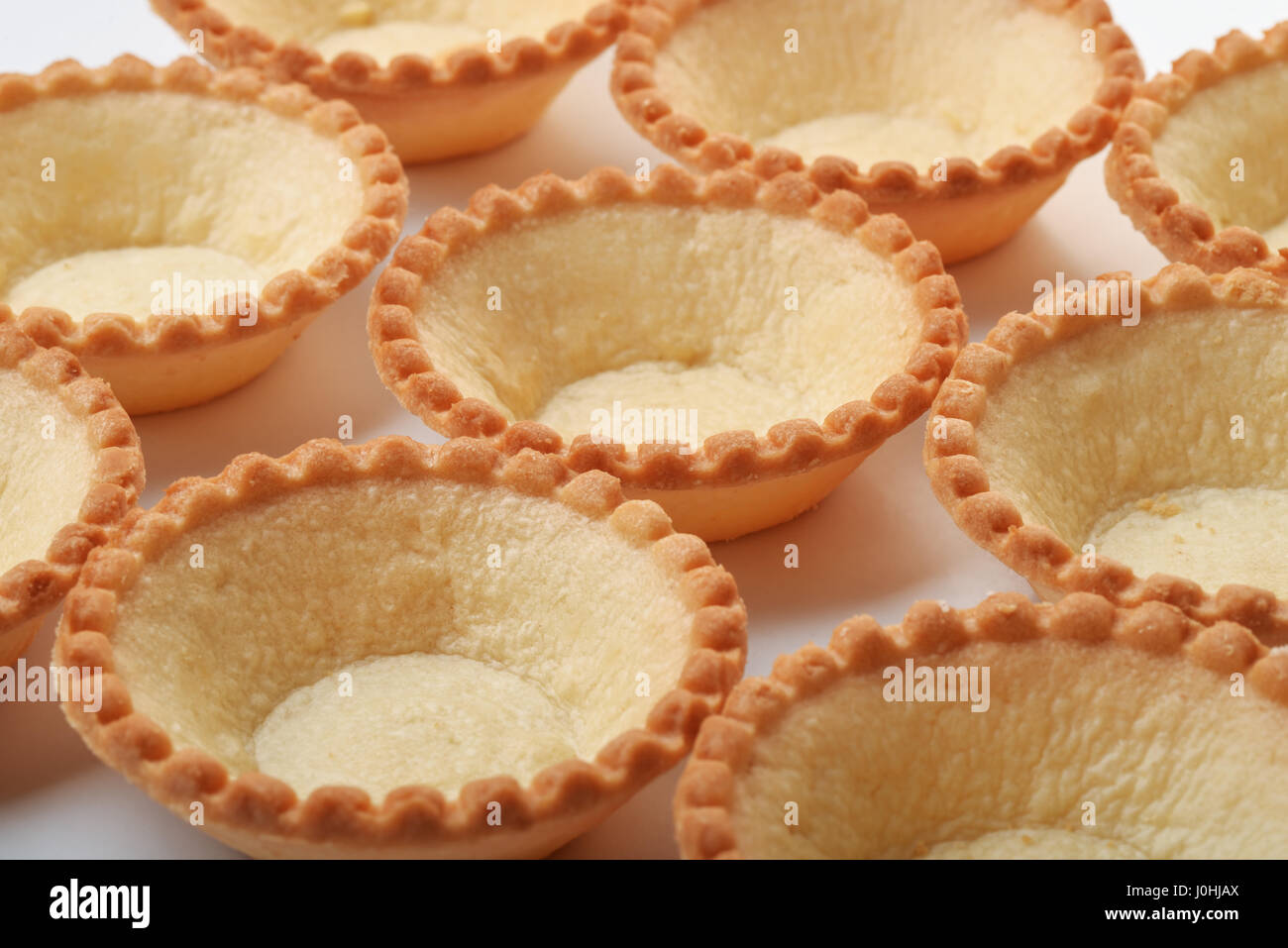 Group of fresh baked empty tart shells Stock Photo - Alamy