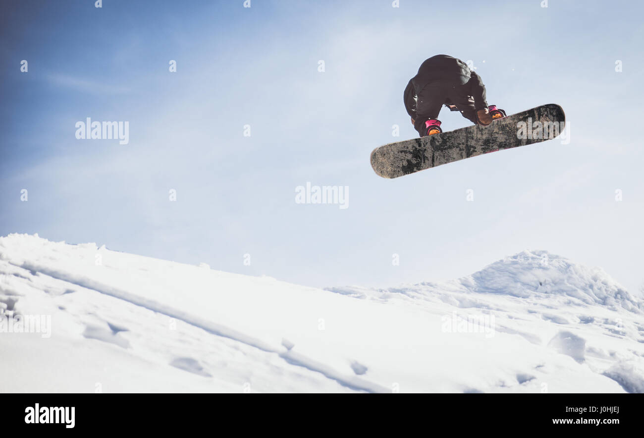 Snoboarder performing tricks on the snow Stock Photo - Alamy