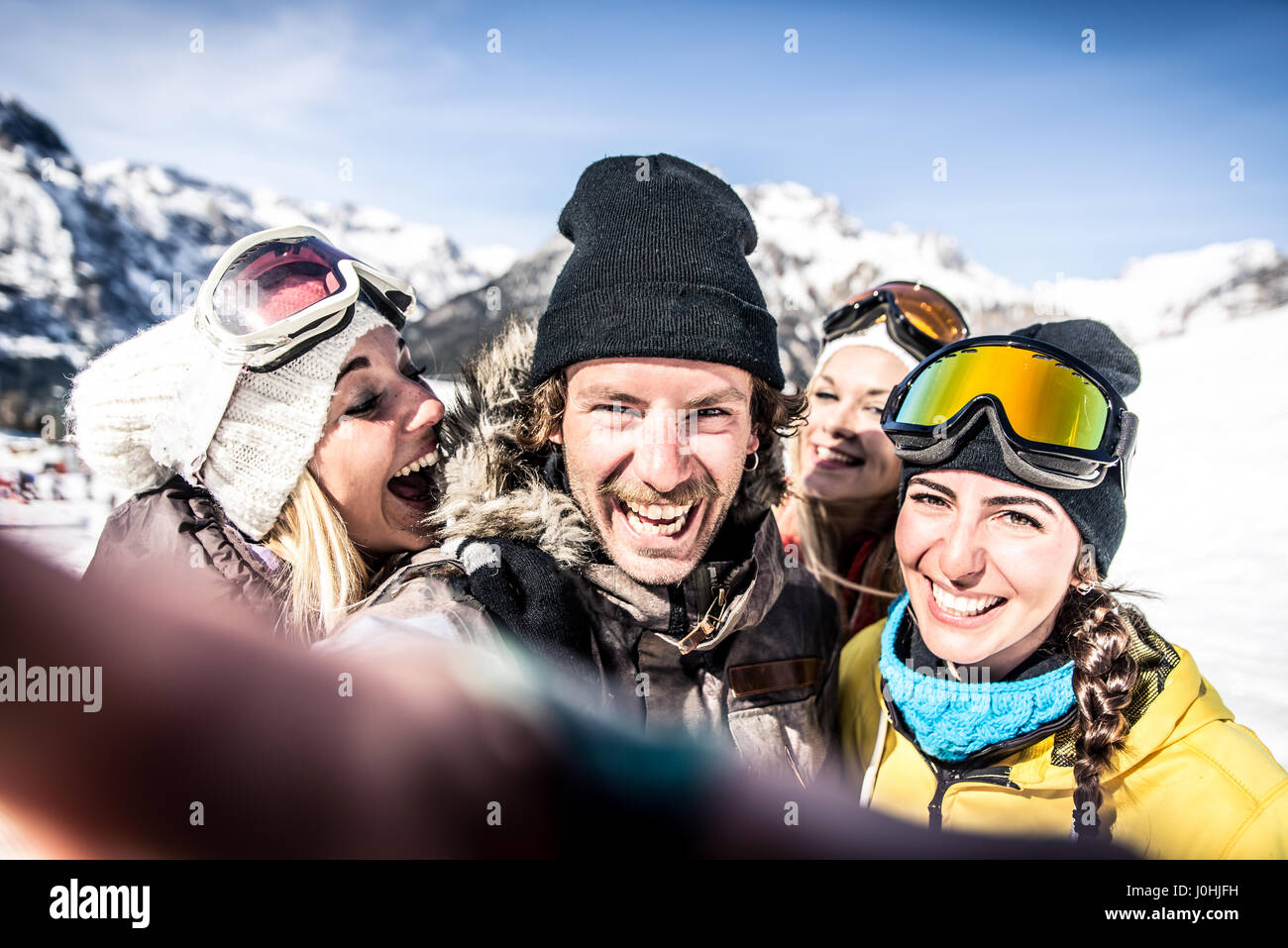 Group of friends having fun on the snow Stock Photo - Alamy