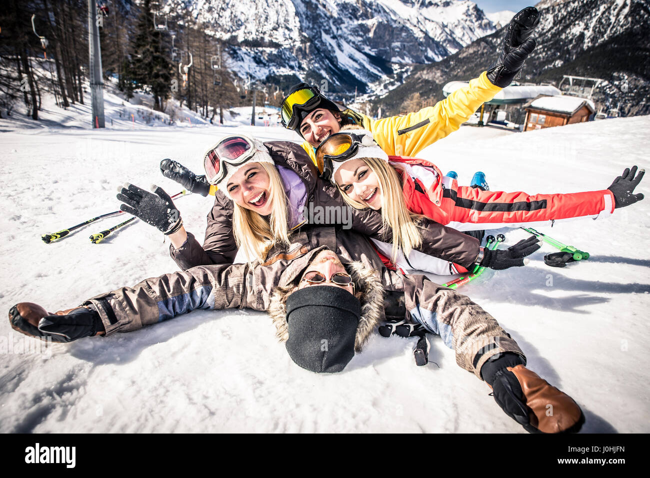 Group of friends having fun on the snow Stock Photo - Alamy