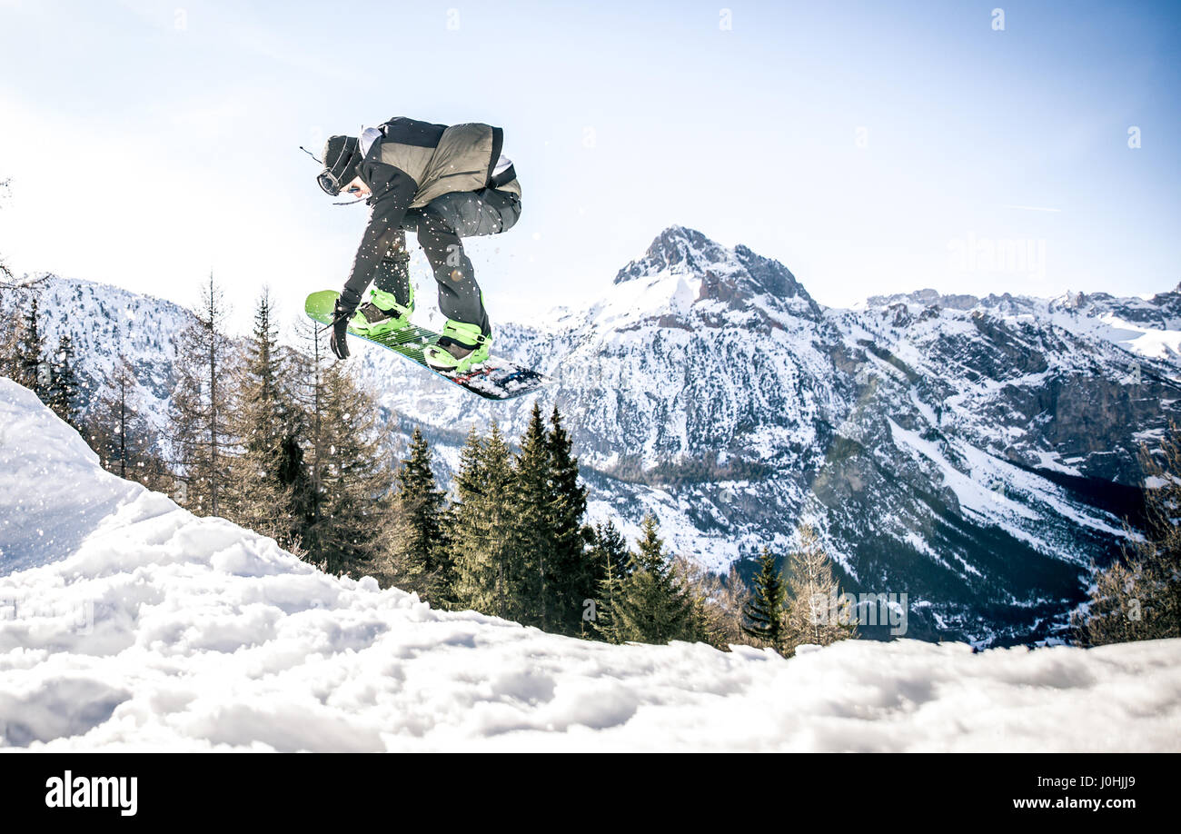 Snoboarder performing tricks on the snow Stock Photo - Alamy