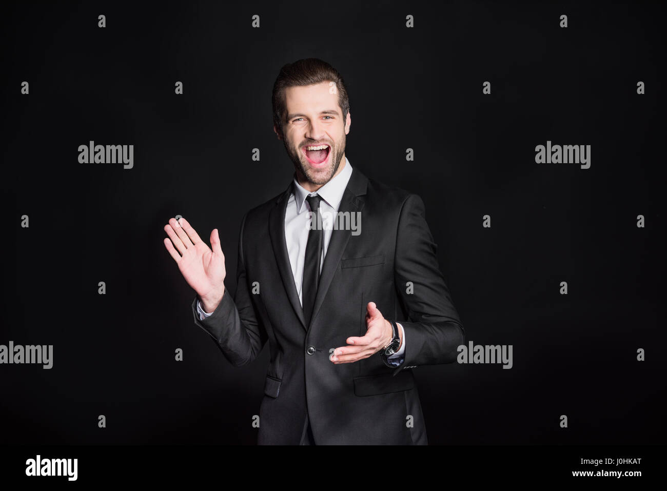 Young handsome businessman laughing and clapping hands on black Stock ...