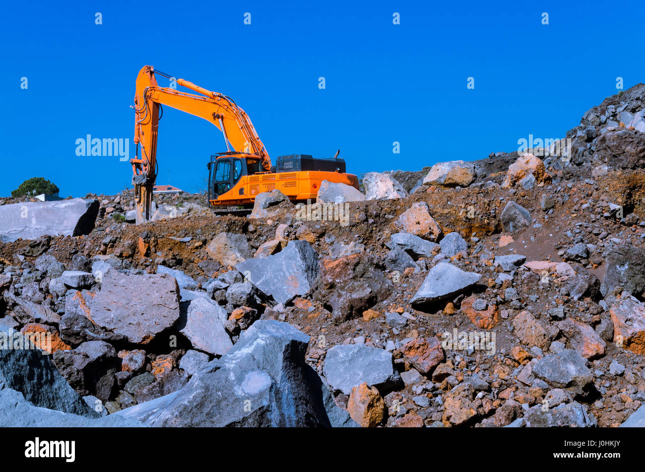 the excavator in a mine in a day's work Stock Photo - Alamy