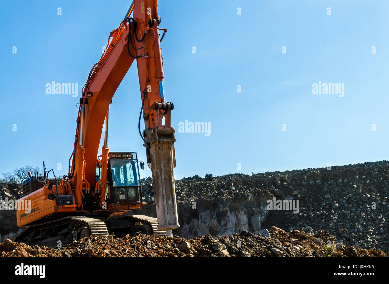 the excavator in a mine in a day's work Stock Photo - Alamy