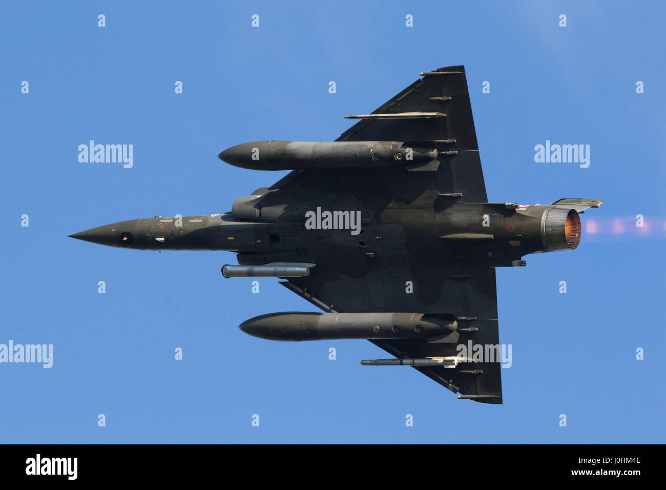 Fast green fighter jet flyby with full afterburner Stock Photo - Alamy