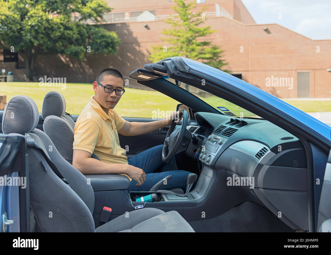 Young chinese man driving car hi-res stock photography and images - Alamy